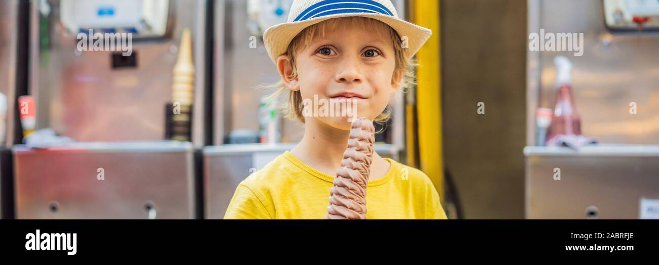 Little tourist boy eating 32 cm ice cream. 1 foot long ice cream. Long ...