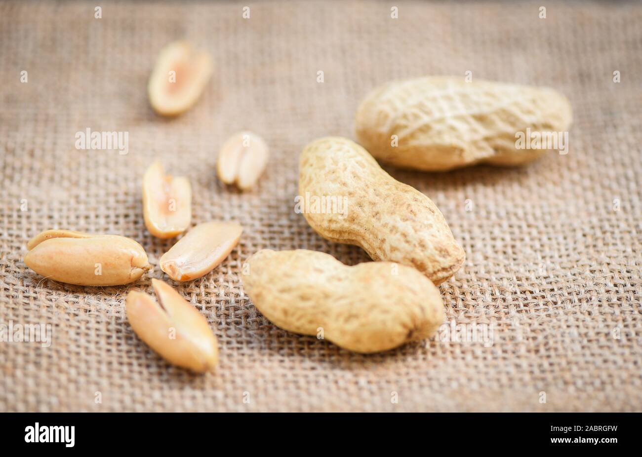 Peanut in shells for food or snack / Roasted peanuts on sack background ...