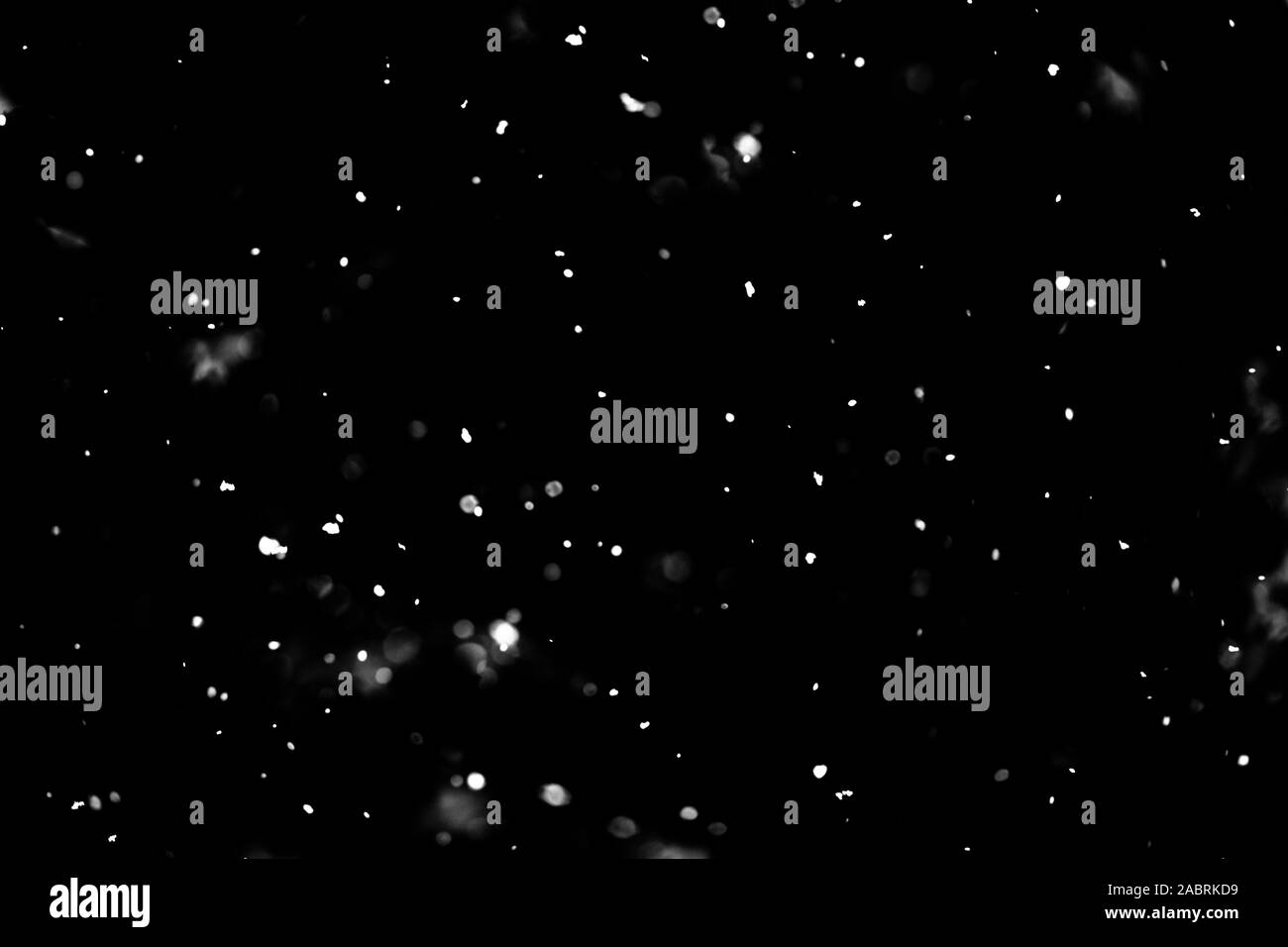 Snow on black background Stock Photo - Alamy