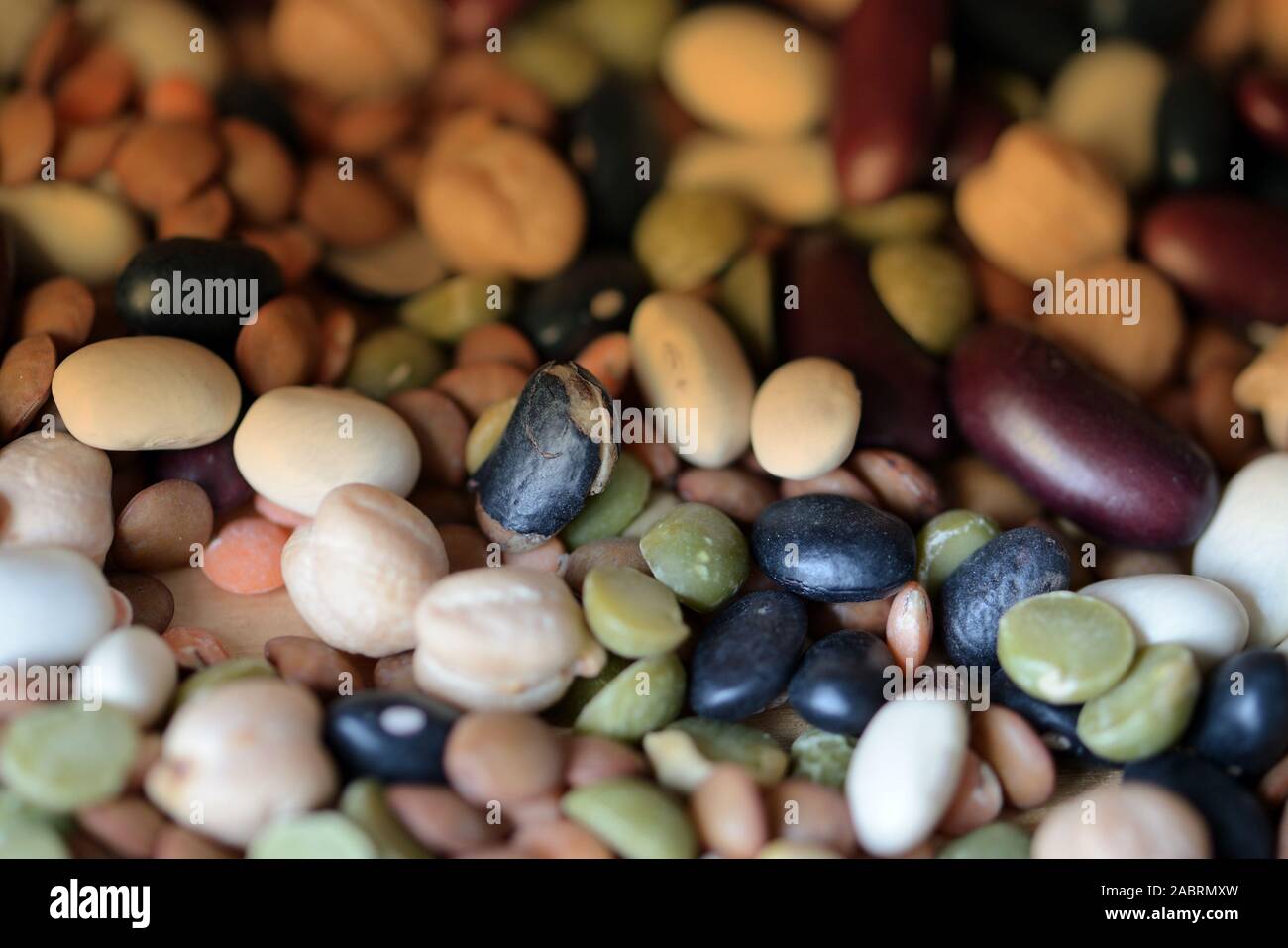 Different beans scattered on a wooden surface close-up. Naturel organic ...