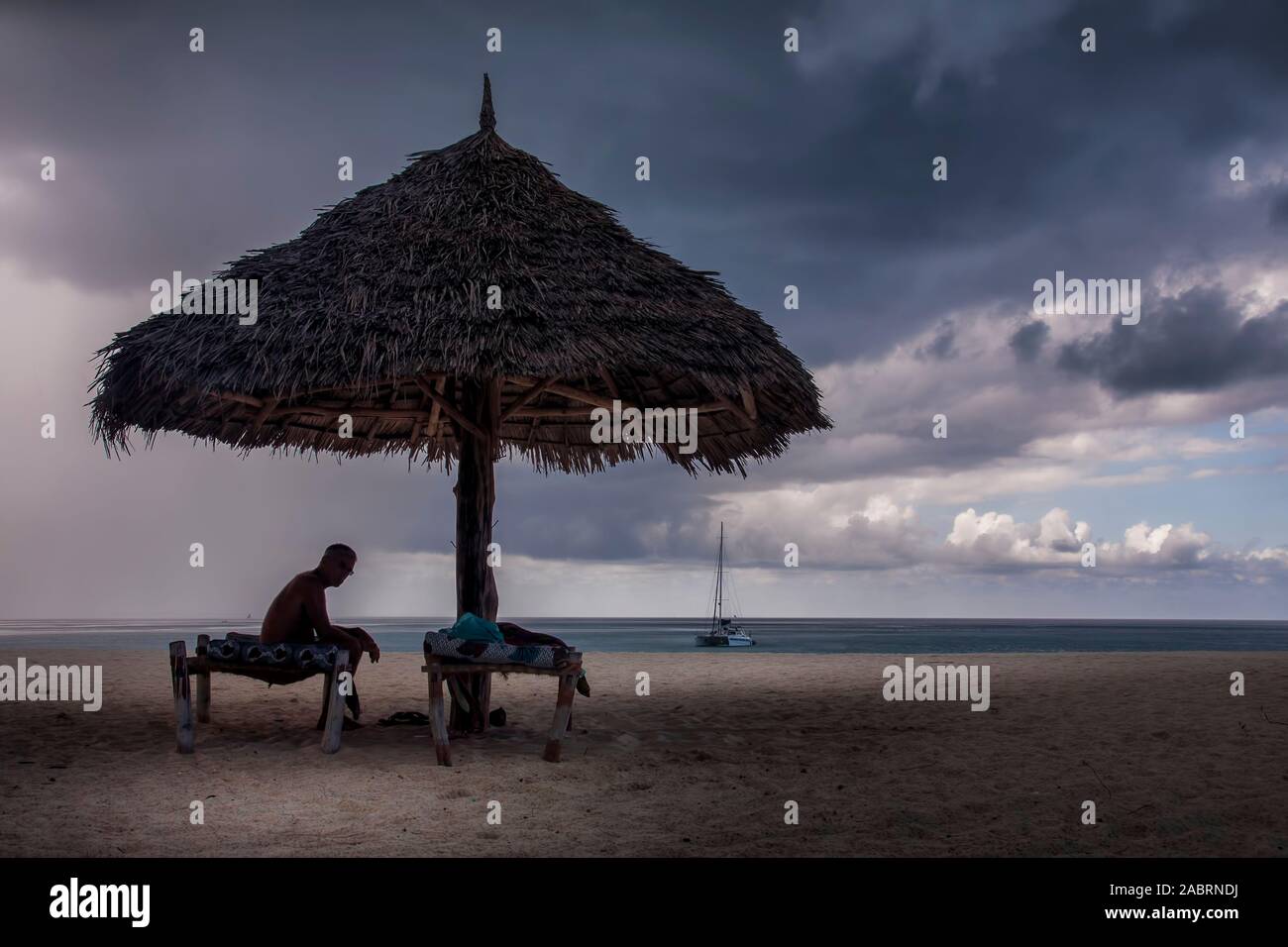 taking cover during a rain storm on Zanzibar Stock Photo - Alamy