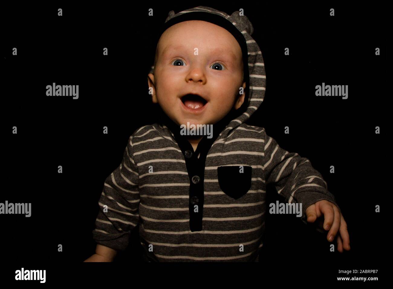 A 4 Month Old Baby Poses on a Black Background. Perfect for Memes with ...