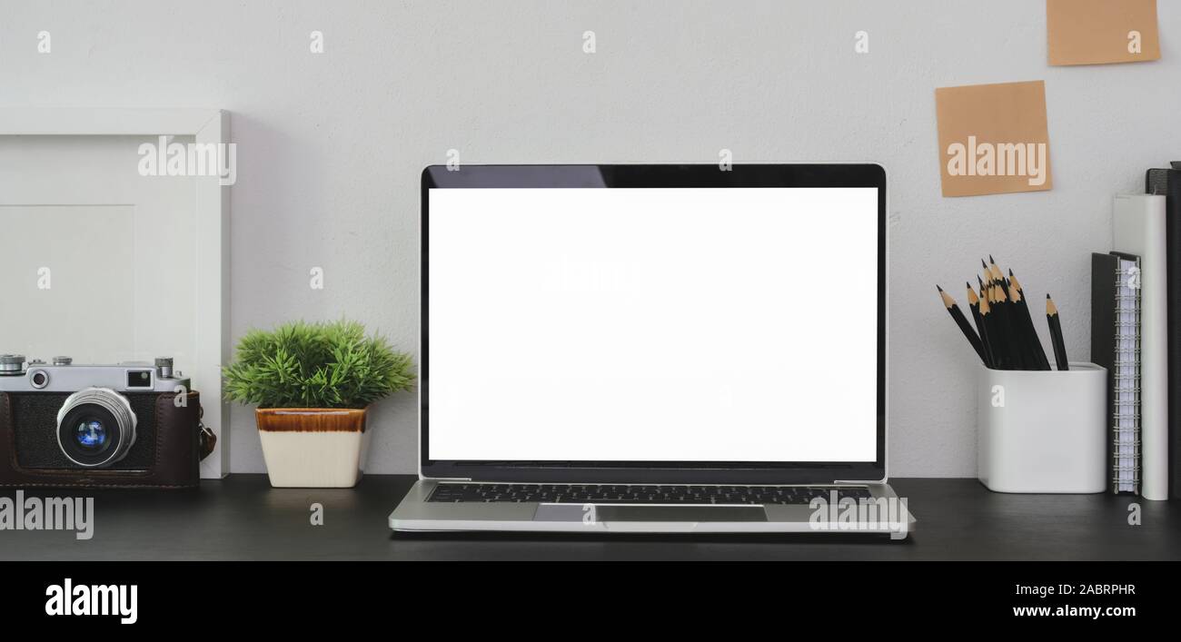 Close-up view of modern office room with blank screen laptop computer ...
