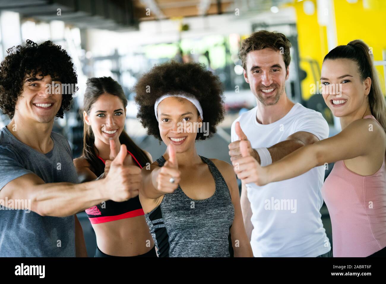Group of happy multiracial friends exercising together in gym Stock ...