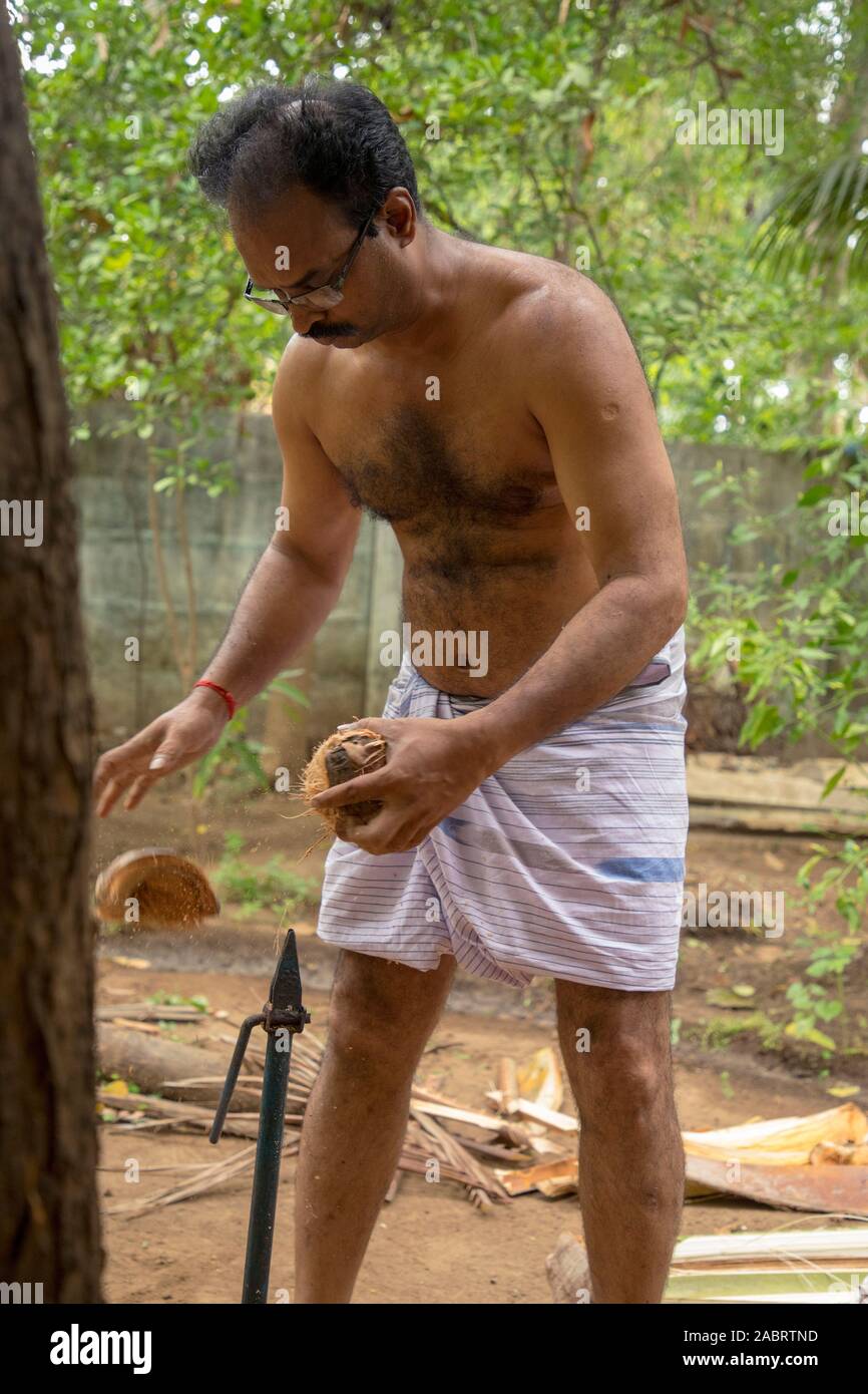 Man open coconut shell by old knife, Nature background Stock Photo - Alamy