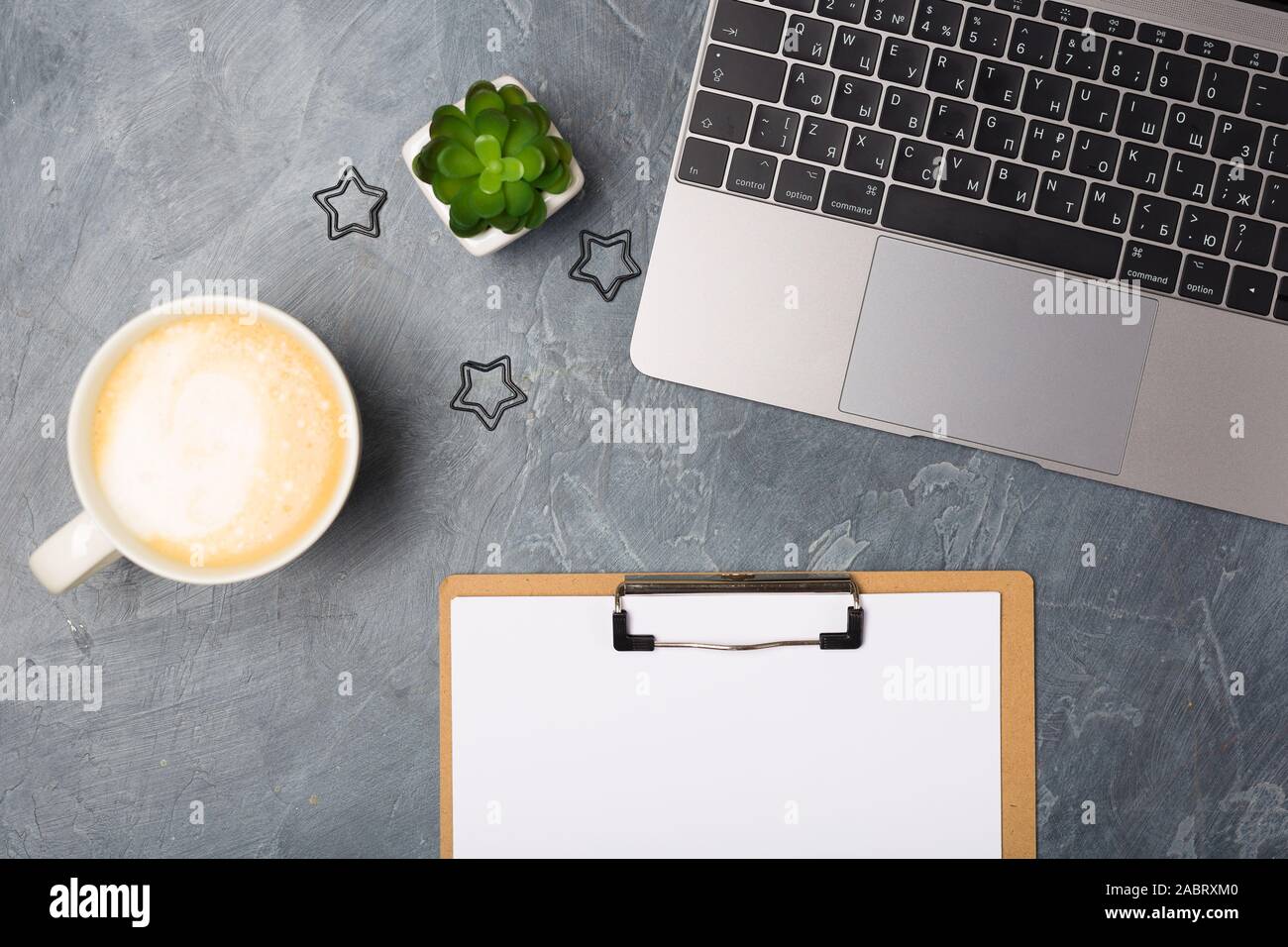Office Flat lay gray desk with silver laptop computer, coffee, and ...