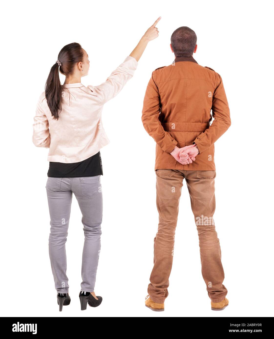 Back view of a stylish couple pointing. beautiful friendly girl and guy ...