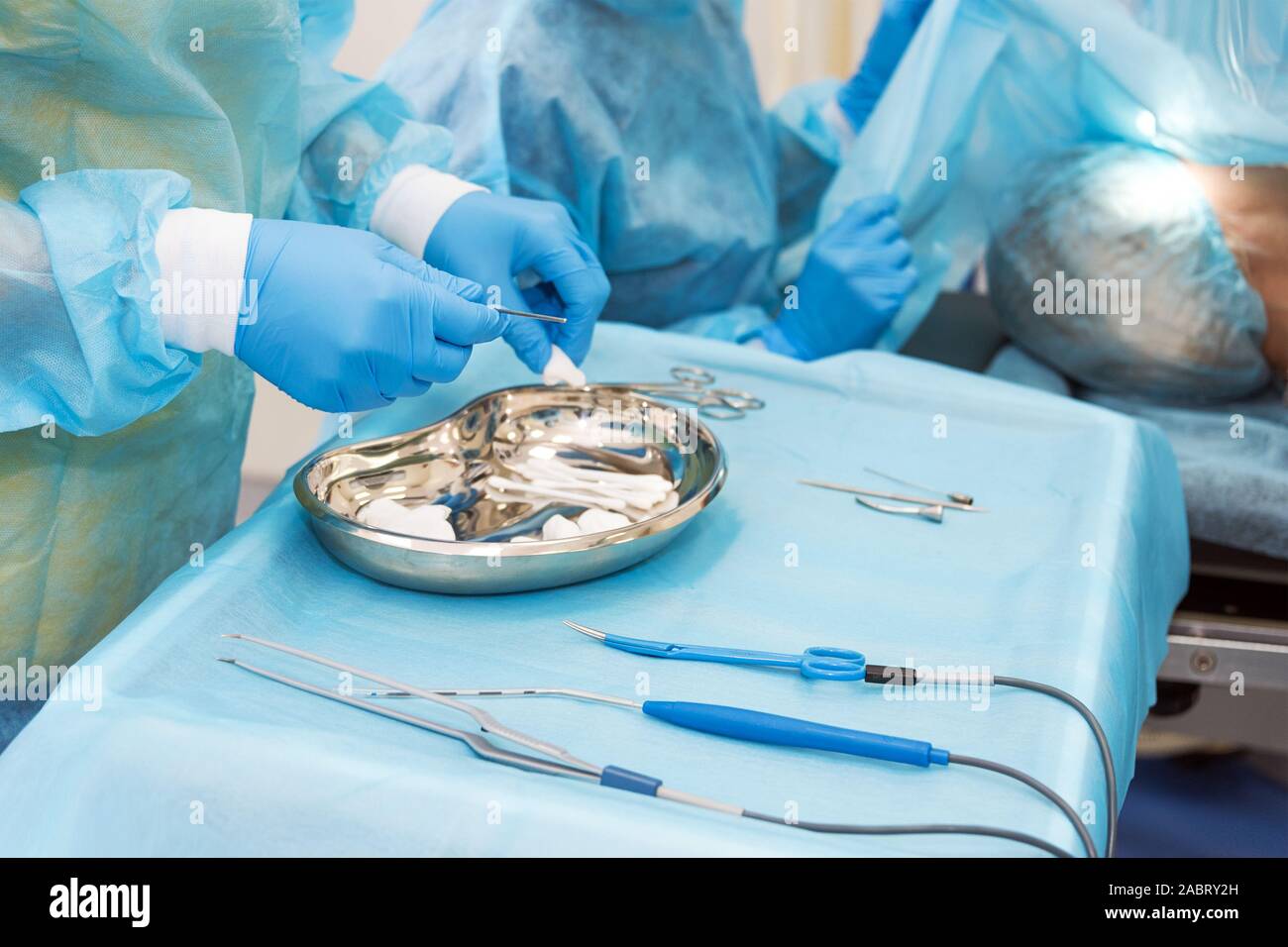 Doctor's hand holding instrument in the operating room. Instruments for ...