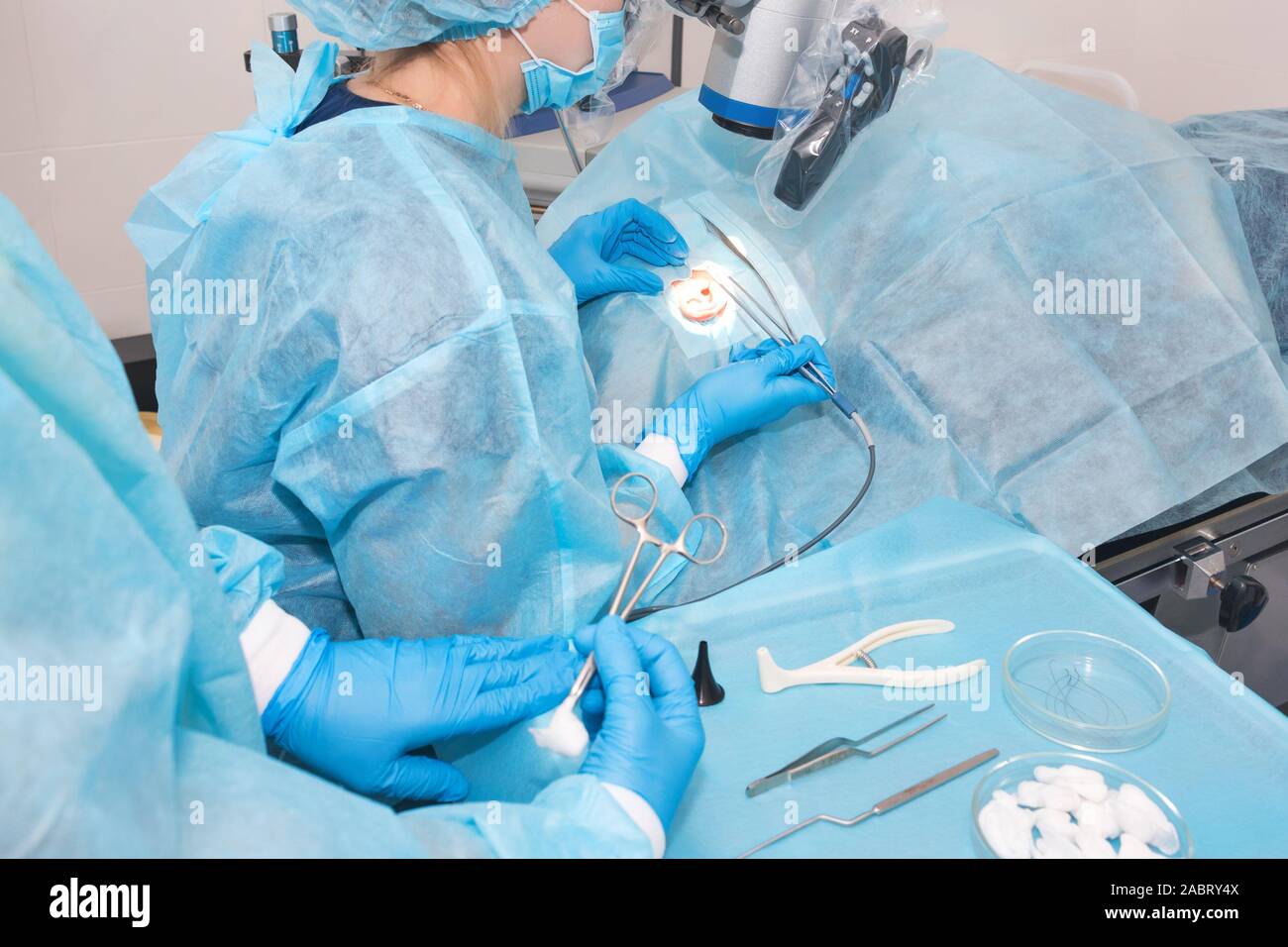 Nurse giving a tool to a doctor during surgery. Hands of doctors during ...