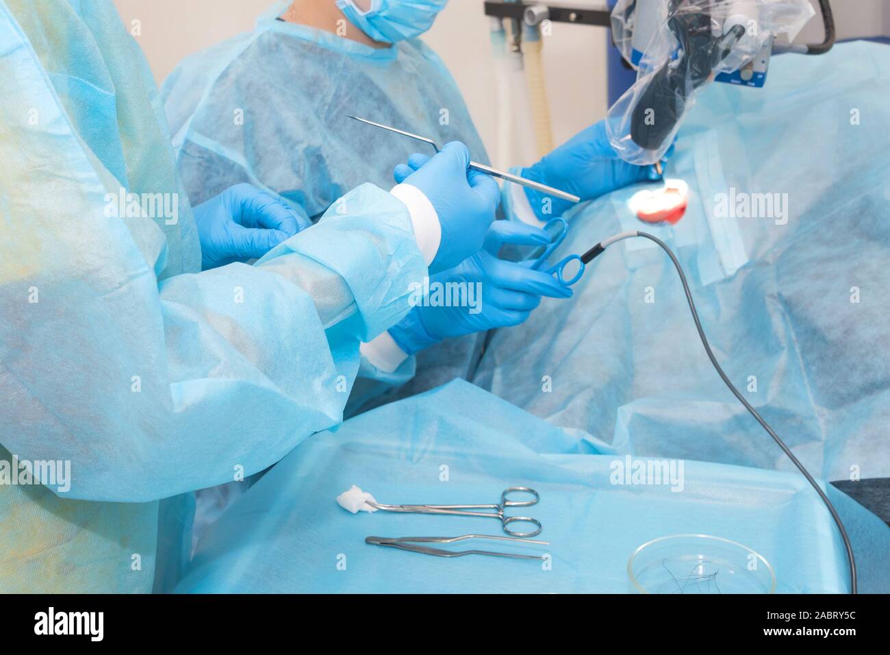 Doctor's hand holding instrument in the operating room. Instruments for ...