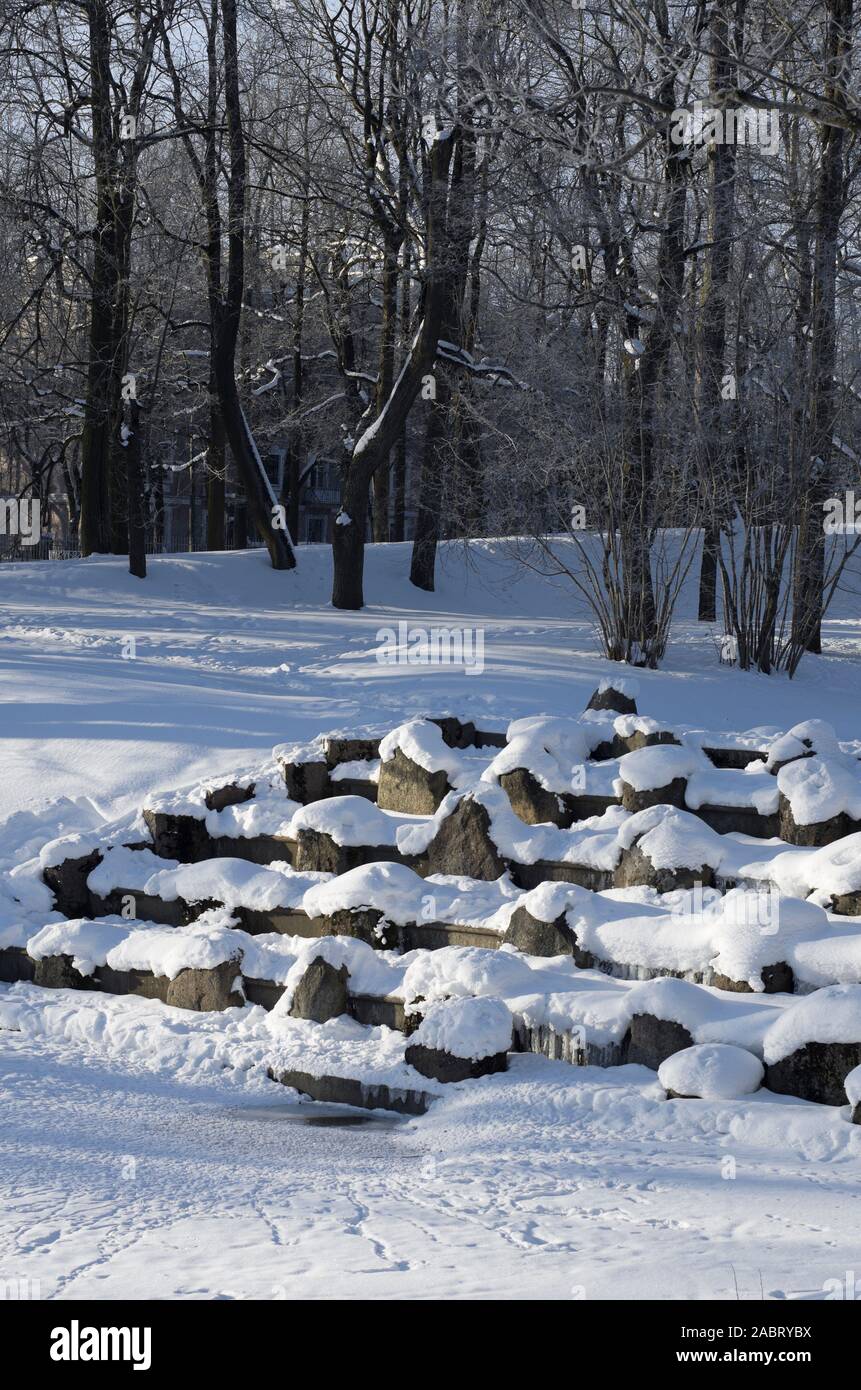 Beautiful winter landscape with snow covered cascade of small waterfall ...