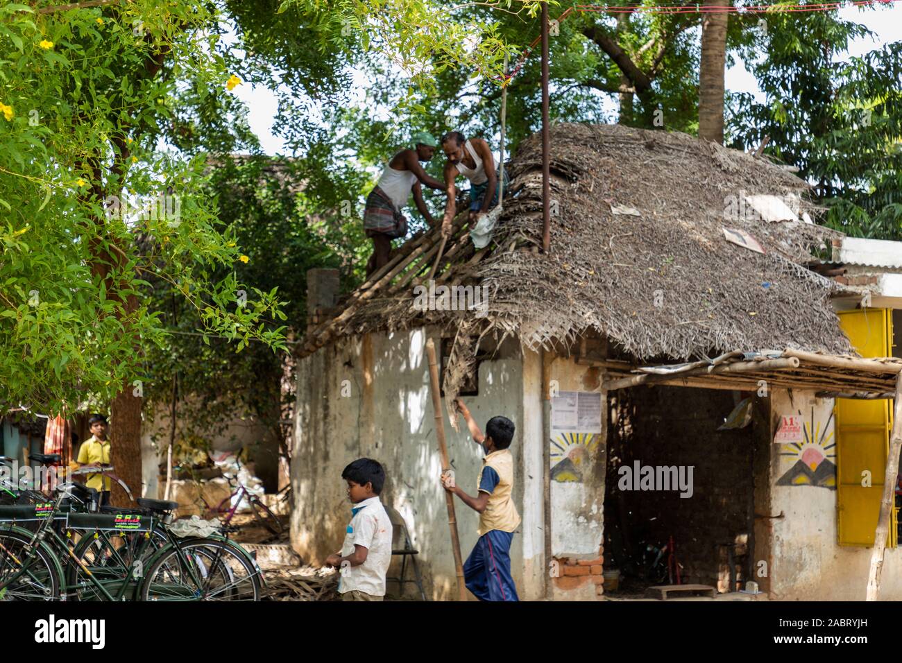 The men replace the roof in a hut Stock Photo - Alamy