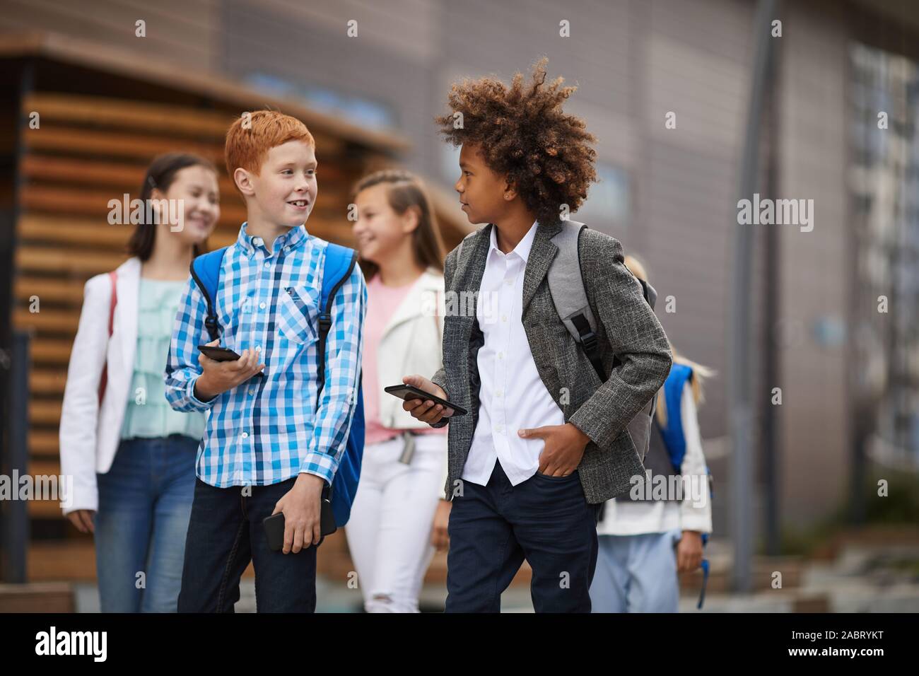Two boys talking street hi-res stock photography and images - Alamy