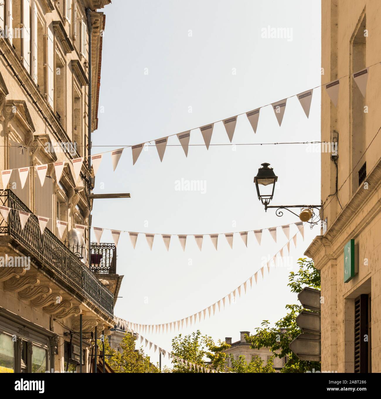 Pretty flags strung between buildings decorates the city of Angouleme ...