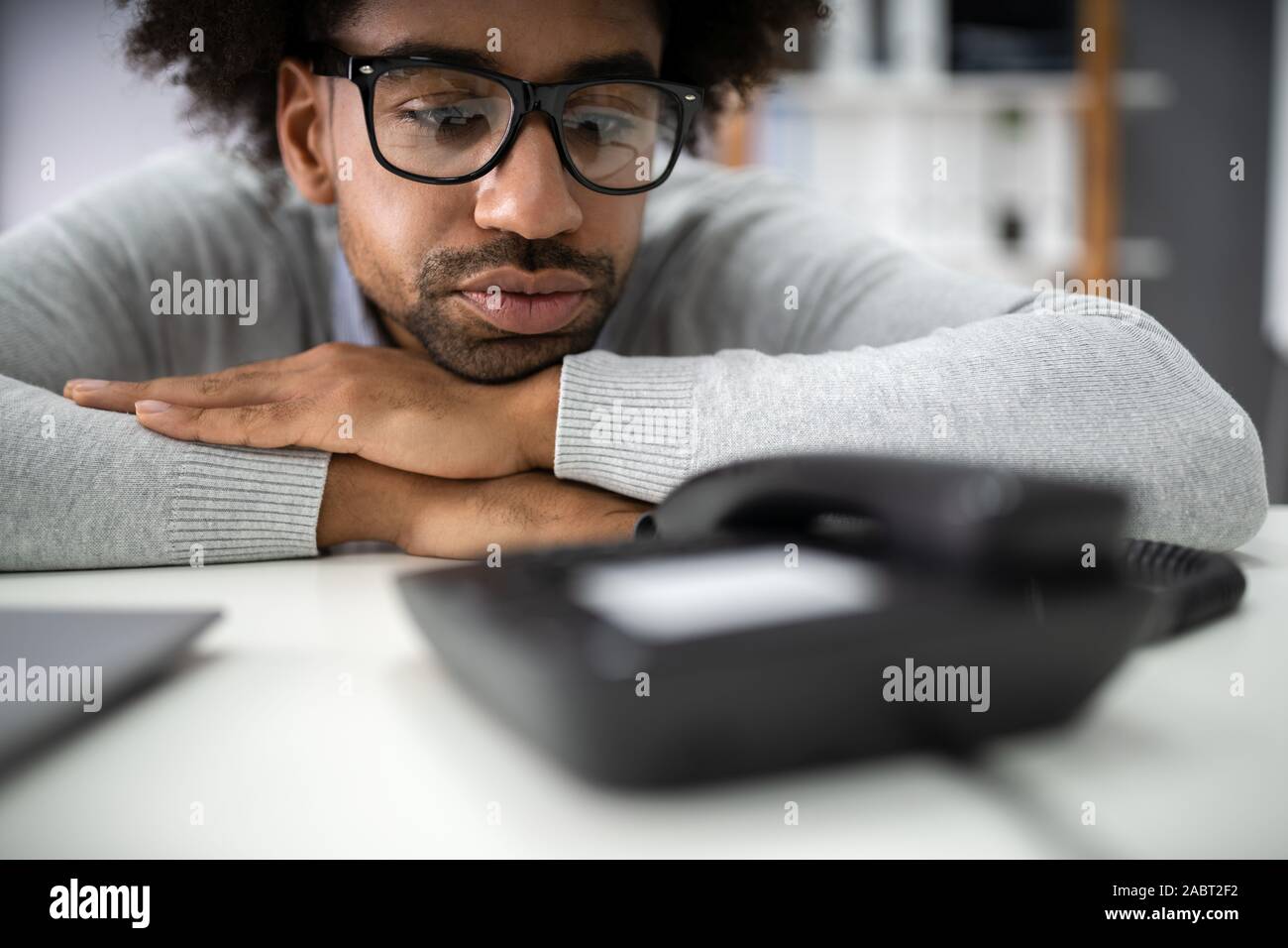 Young Businessman Waiting For A Call On Landline Stock Photo - Alamy