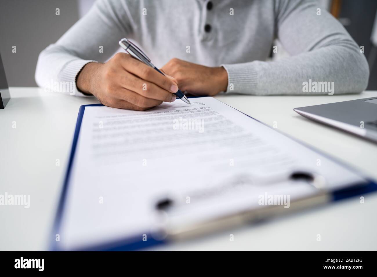 African man signing paper hi-res stock photography and images - Alamy