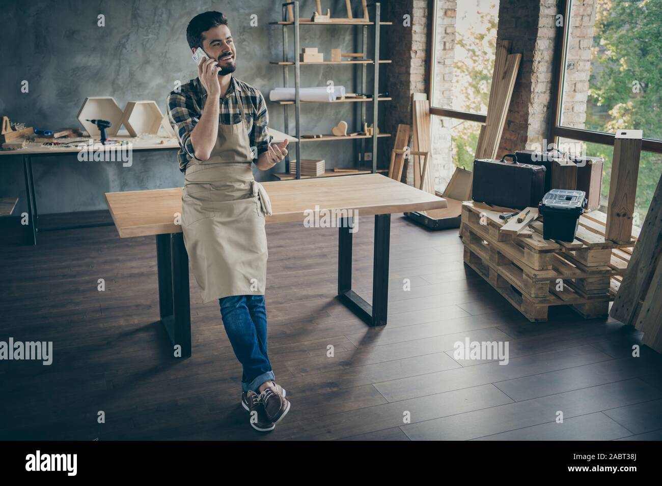 Full body photo of handsome guy master answering client call listening ...