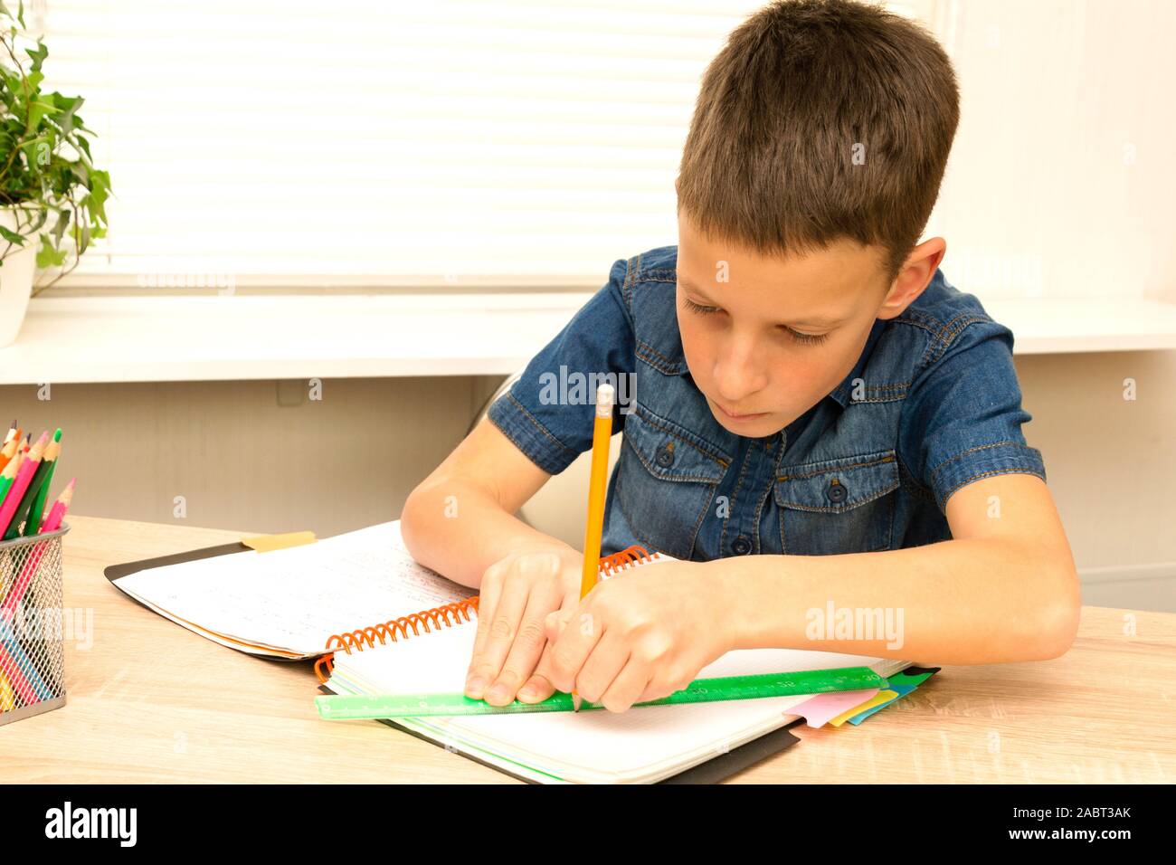 8 years old boy doing his homework - education Stock Photo - Alamy