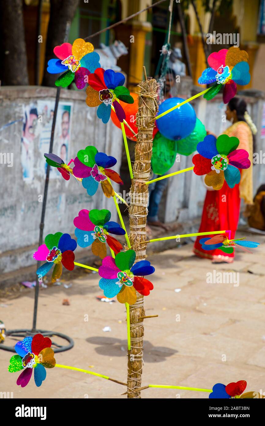 vendor selling colorful plastic windmill on Indian temple festival ...