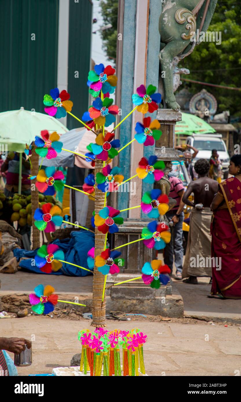 vendor selling colorful plastic windmill on Indian temple festival ...