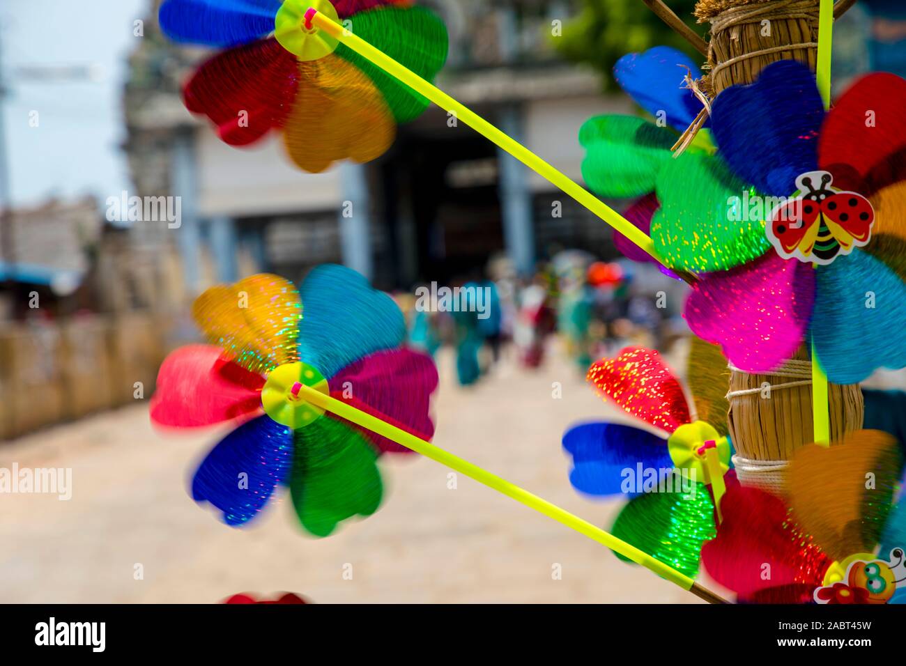 vendor selling colorful plastic windmill on Indian temple festival ...