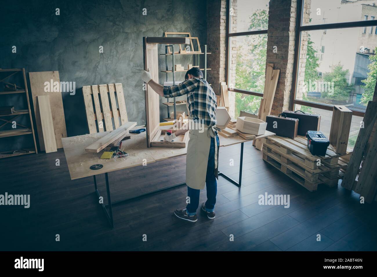 Back rear side full length photo of concentrated worker handcraft ...