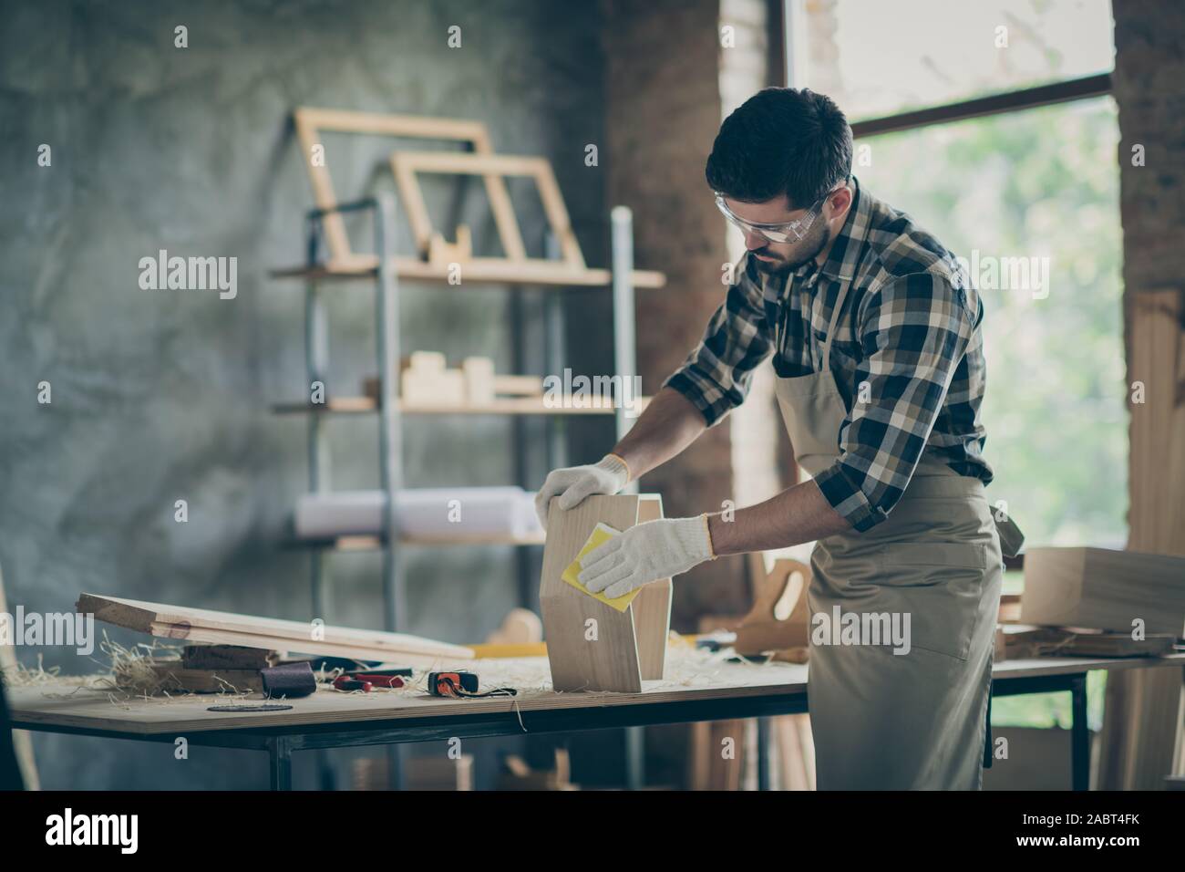 Profile side photo of concentrated man foreman work with wooden shelf ...