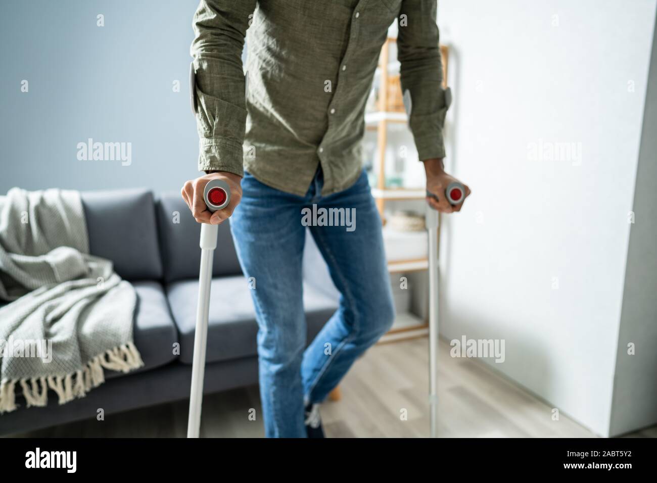 Disabled Man Using Crutches For Walking On Floor Stock Photo - Alamy