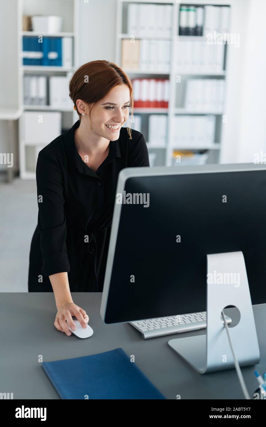 Woman standing behind desktop hi-res stock photography and images - Alamy
