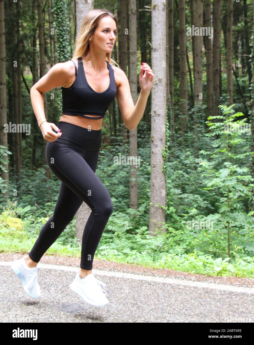 beautiful young woman jogging outdoors in the park Stock Photo - Alamy