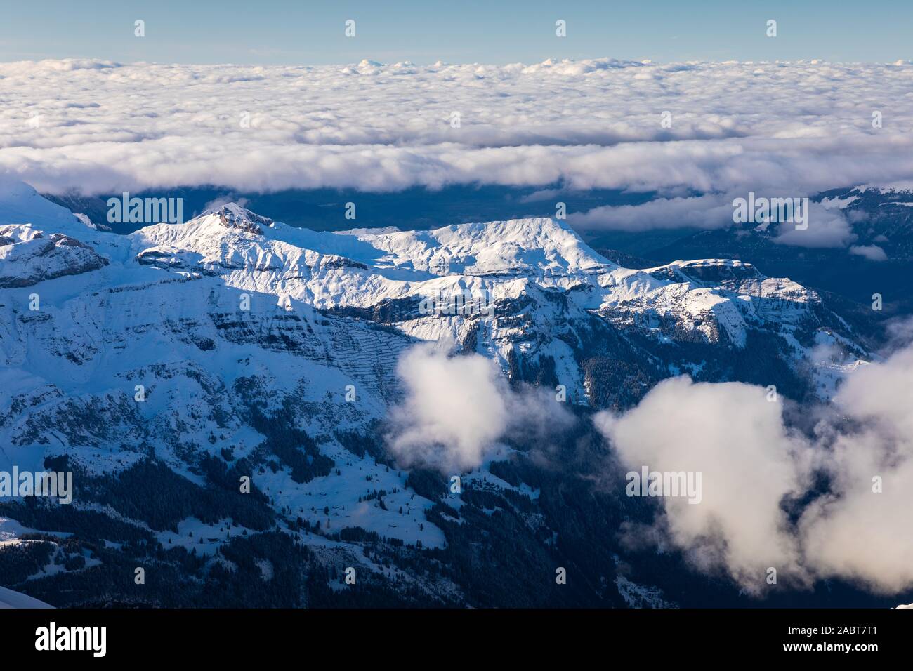 Aerial of snowcapped mountain range of Jungfrau in winter before sunset ...