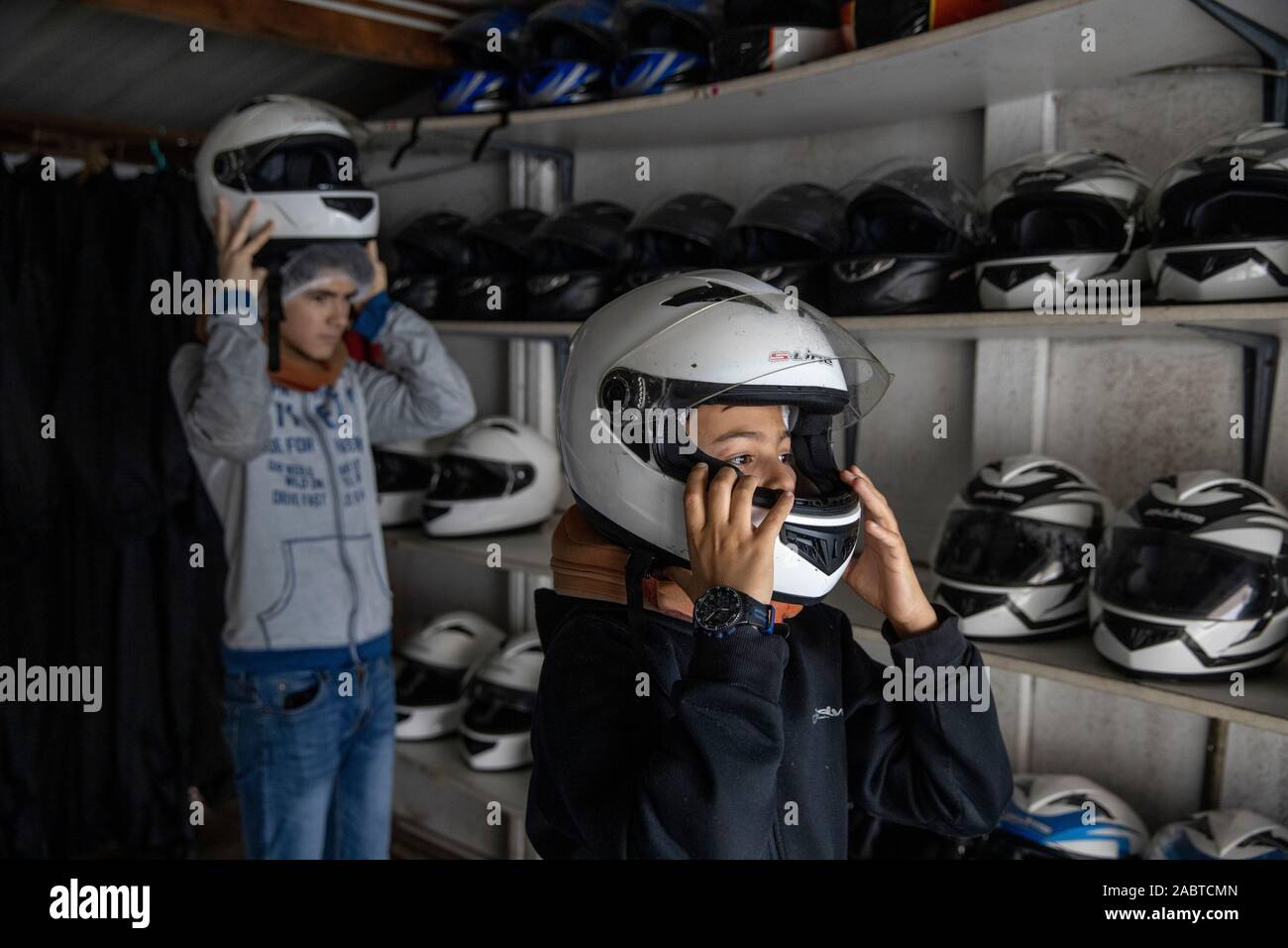 Boy putting on his helmet hi-res stock photography and images - Alamy