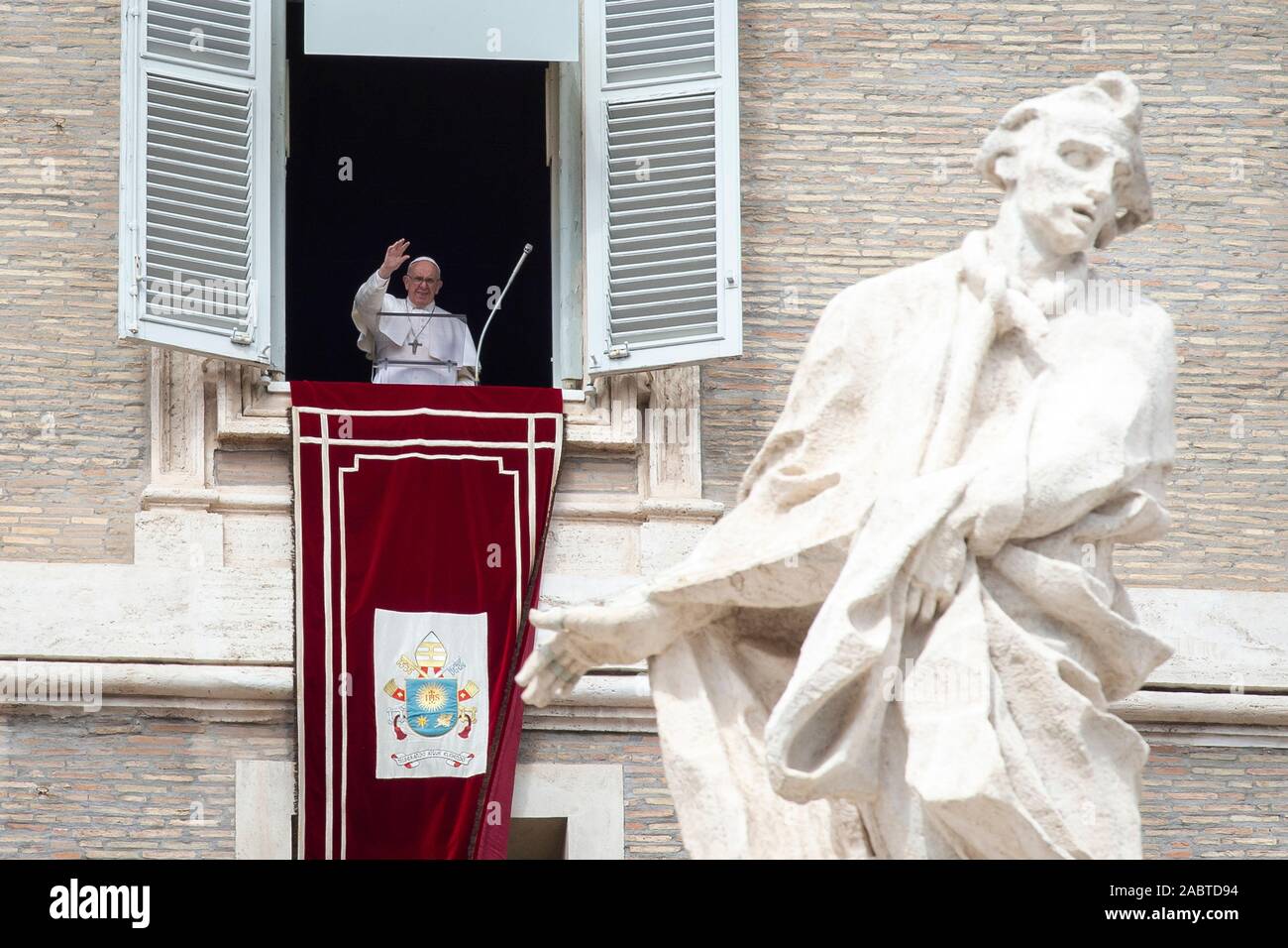 Pope Francis salutes the faithful from the window of the apostolic ...