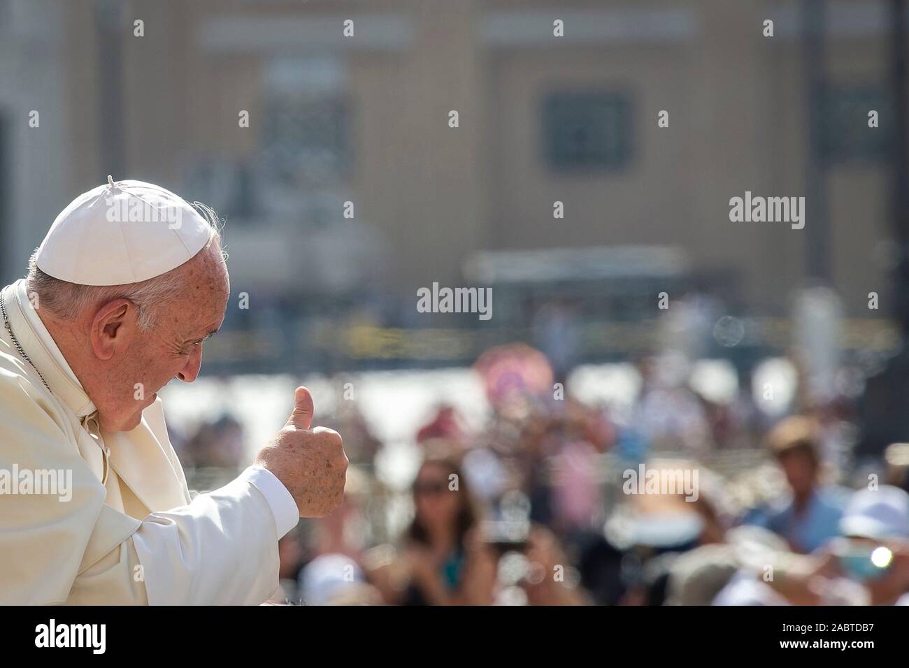 Pope Francis thumbs up the faithful as he arrives for his weekly ...