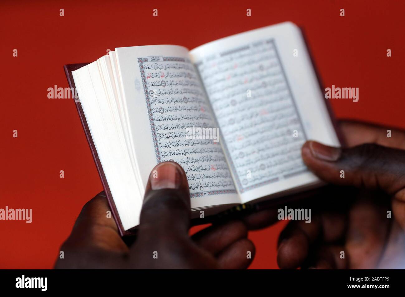 African muslim man reading the Quran. Close-up on hands. Togo Stock ...