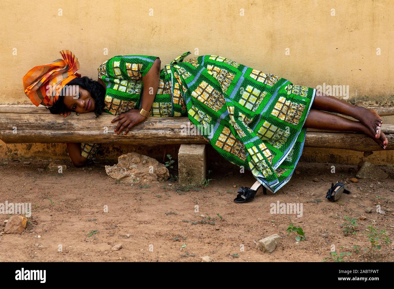 African woman lying on a bench in Kpalime, Togo Stock Photo - Alamy