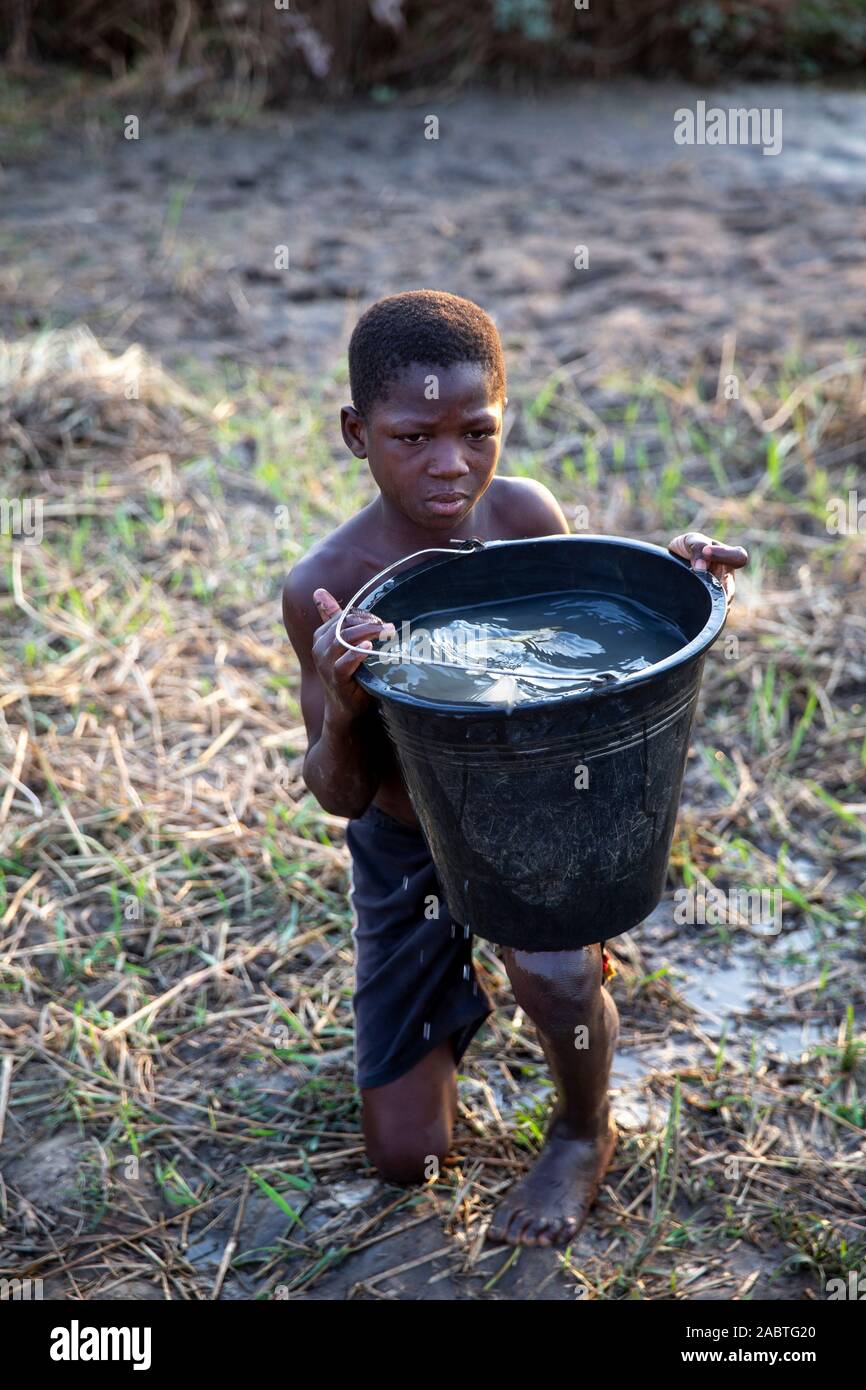 Boy watering a field in Karsome, Togo Stock Photo - Alamy