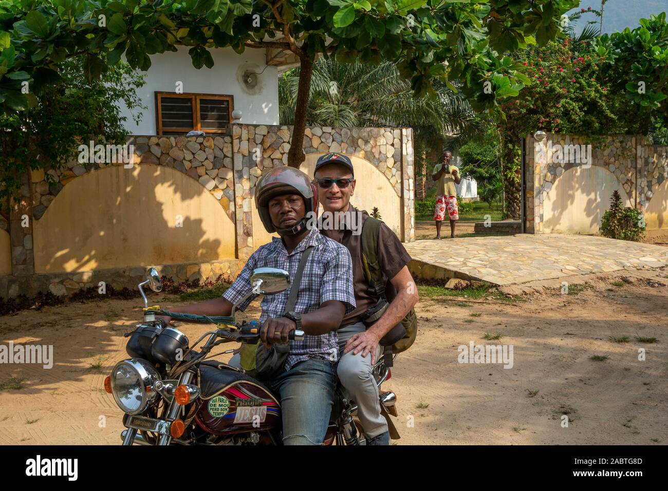 French photographer on a motorcycle taxi in Kpalime, Togo Stock Photo ...