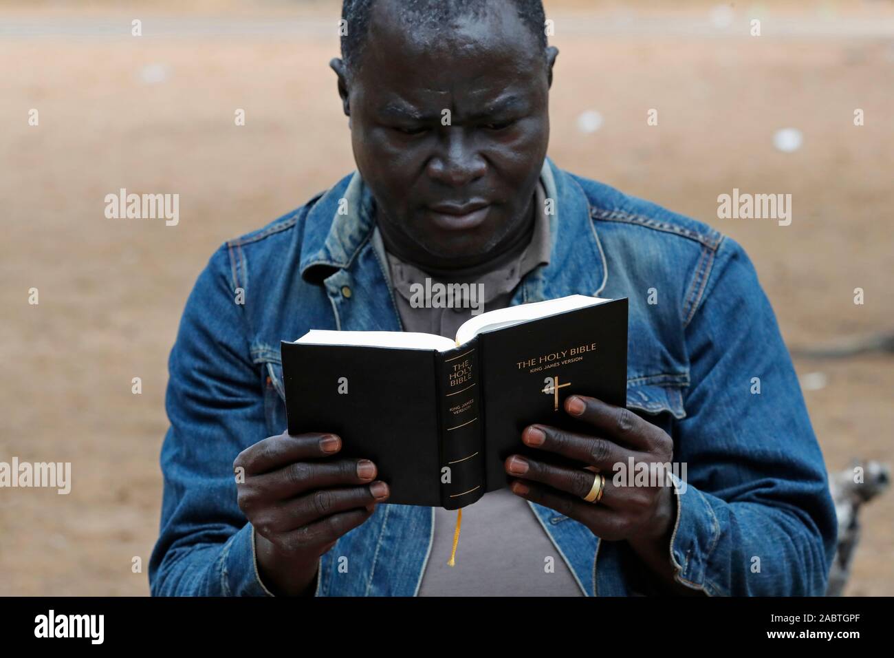 Bible study. African man reading the holy bible. Lome. Togo Stock Photo ...