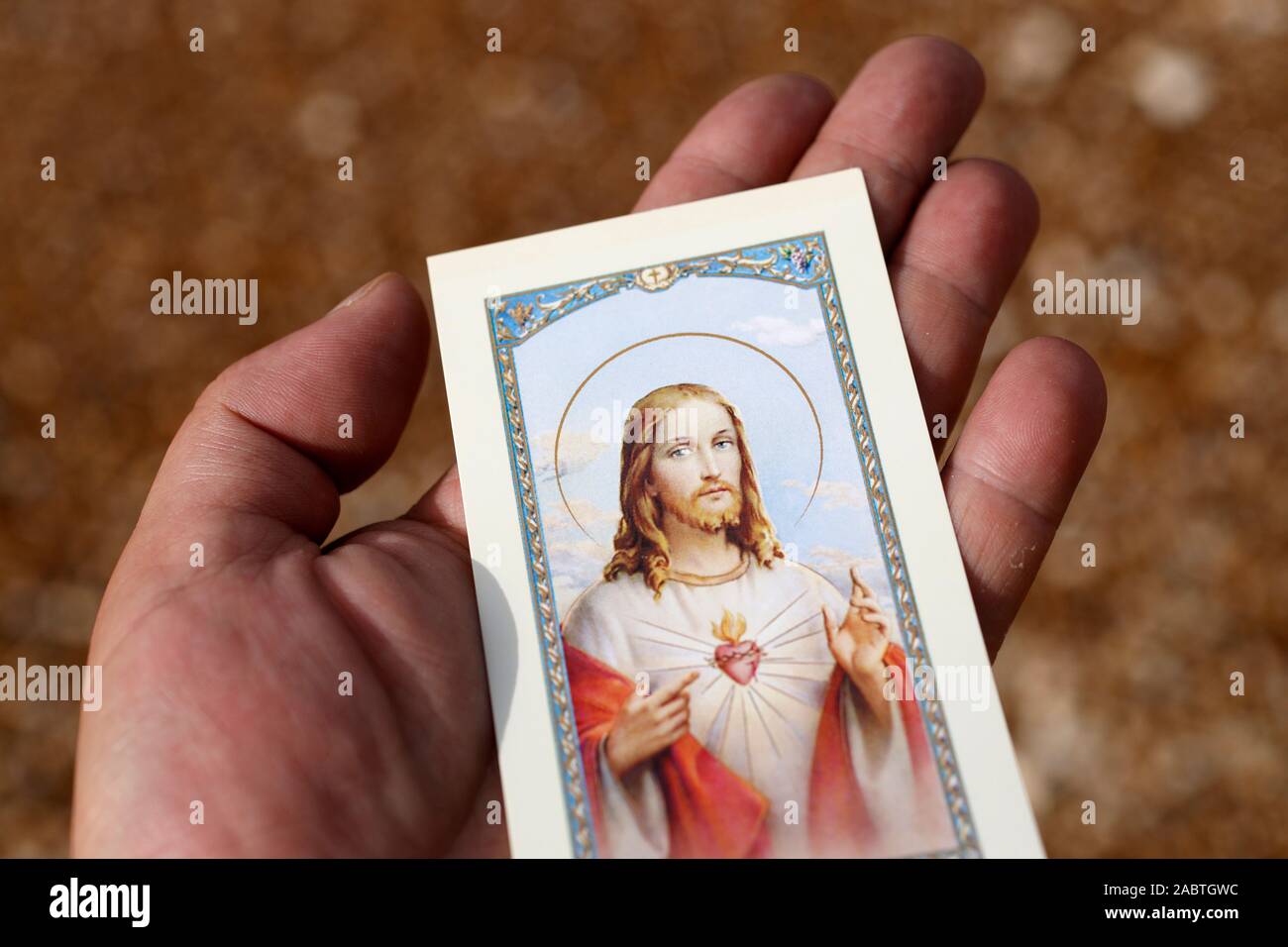 Devotion to the Sacred Heart of Jesus. Holy image in hand Stock Photo ...