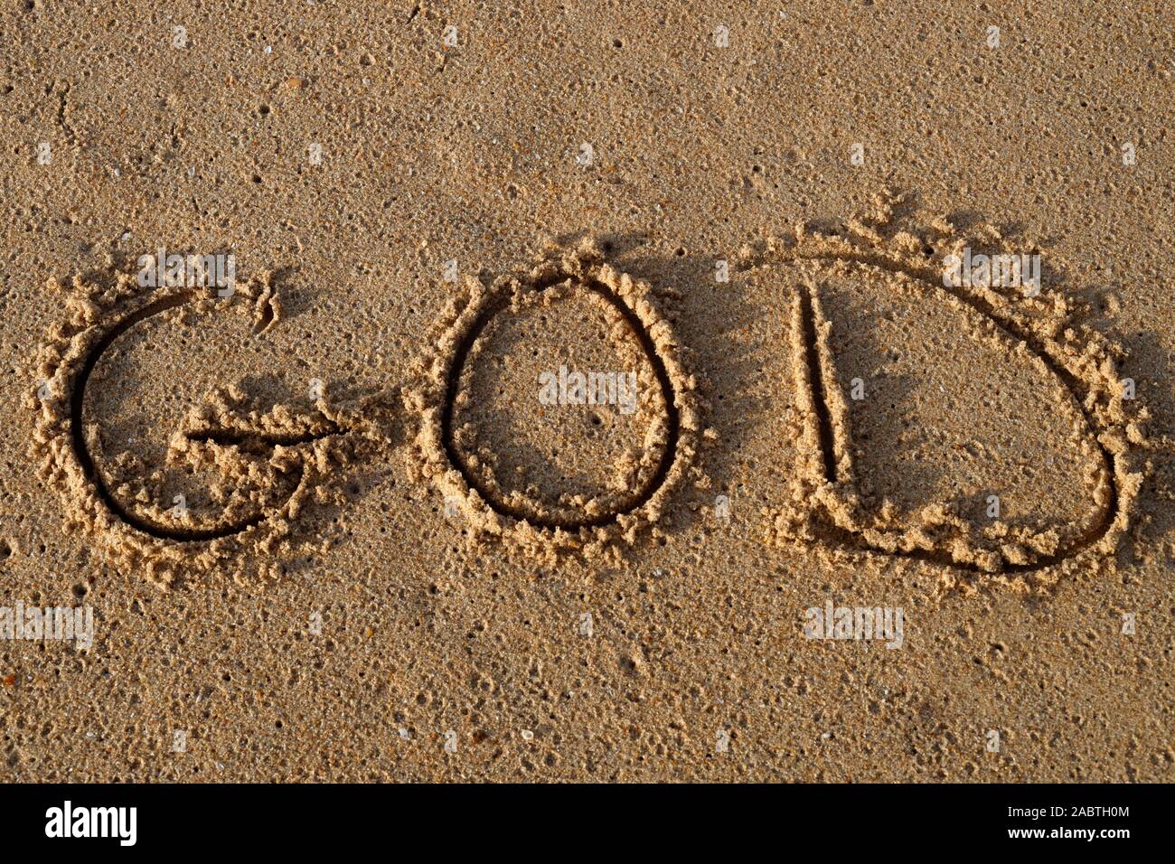 The name of God written in wet sand on beach Stock Photo - Alamy