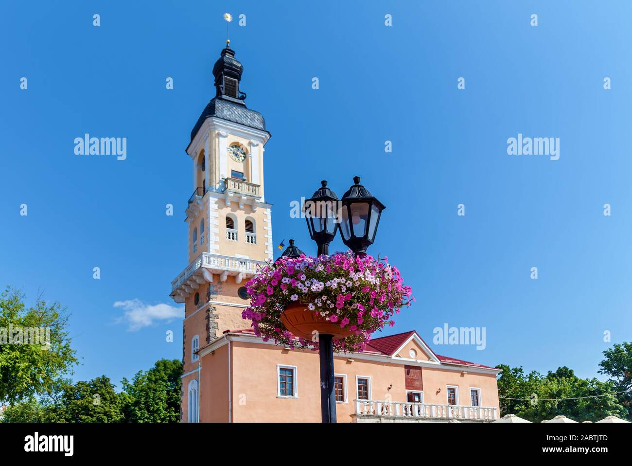 The ancient town hall at the center of Kamenetz-Podolsk on blue cloudy ...