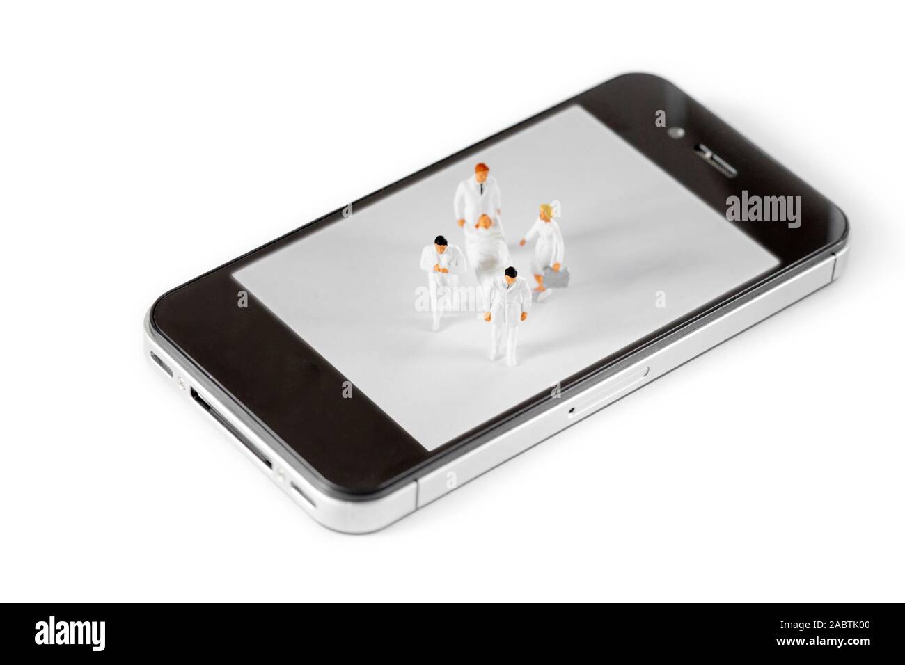 Doctor miniature figurine placed on a smartphone seeming to have an ...