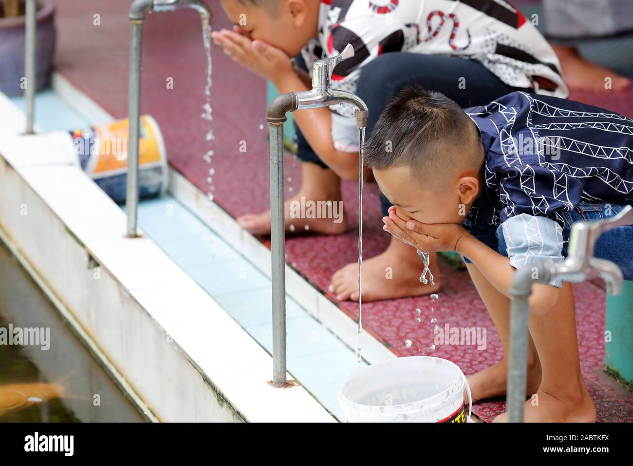 Cholon Jamail Mosque. Children performing ablution prior to Salat. Ho ...