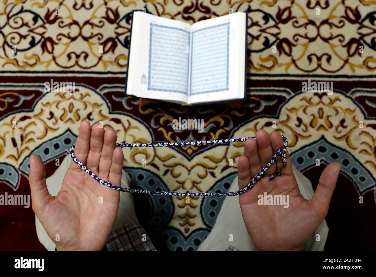 Muslim man praying with prayer beads (Masbahah ). Close-up Stock Photo ...