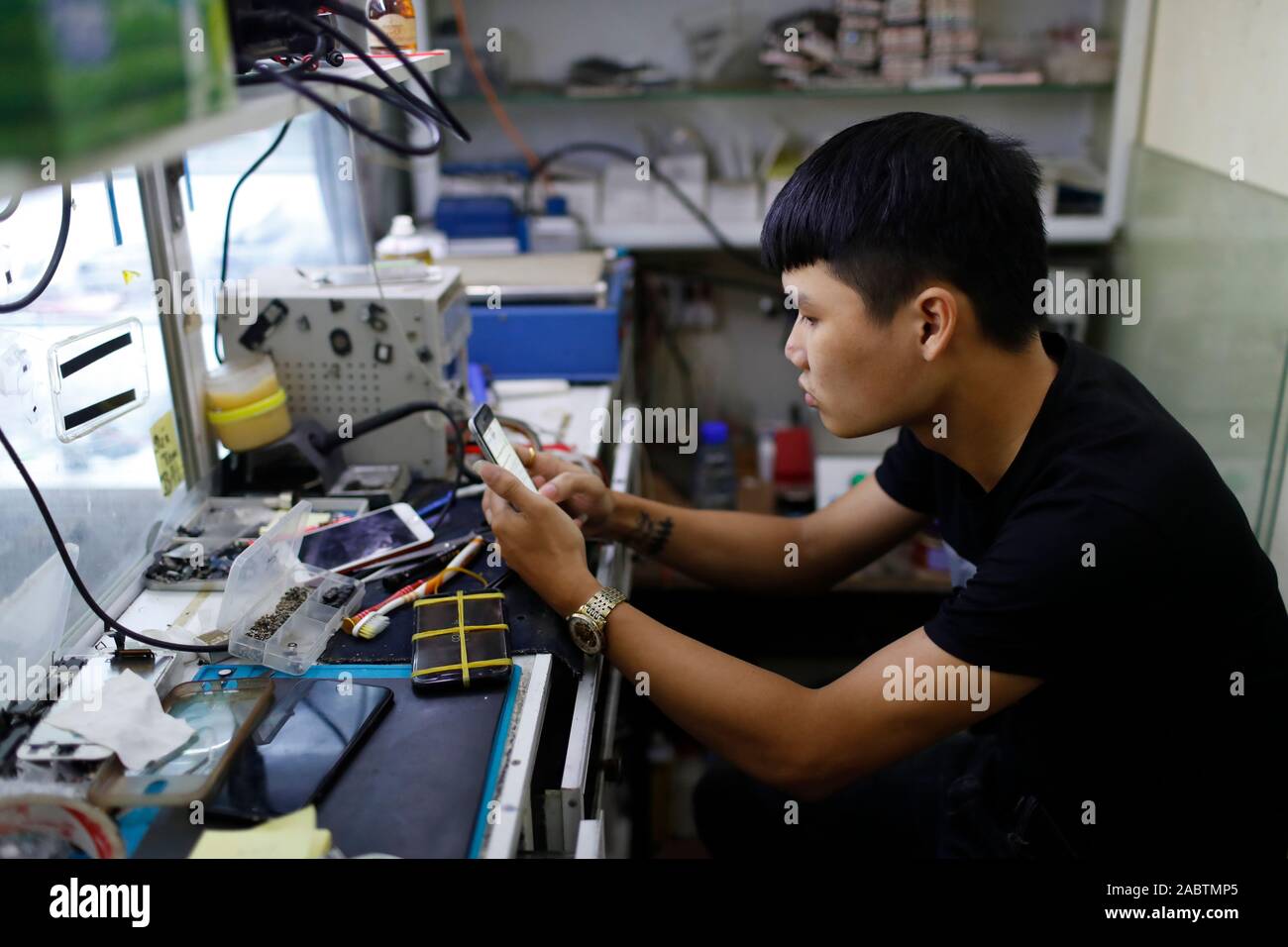 Mobile phone repair. Man is changing a broken mobile phone display in ...