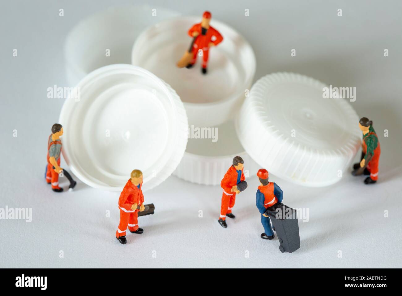 Miniature Garbage man recycling and cleaning a soft drink can to ...