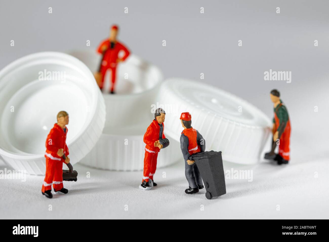 Miniature Garbage man recycling and cleaning a soft drink can to ...