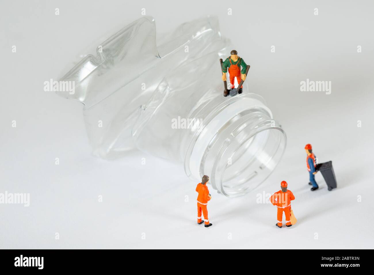Miniature Garbage man recycling and cleaning a soft drink can to ...