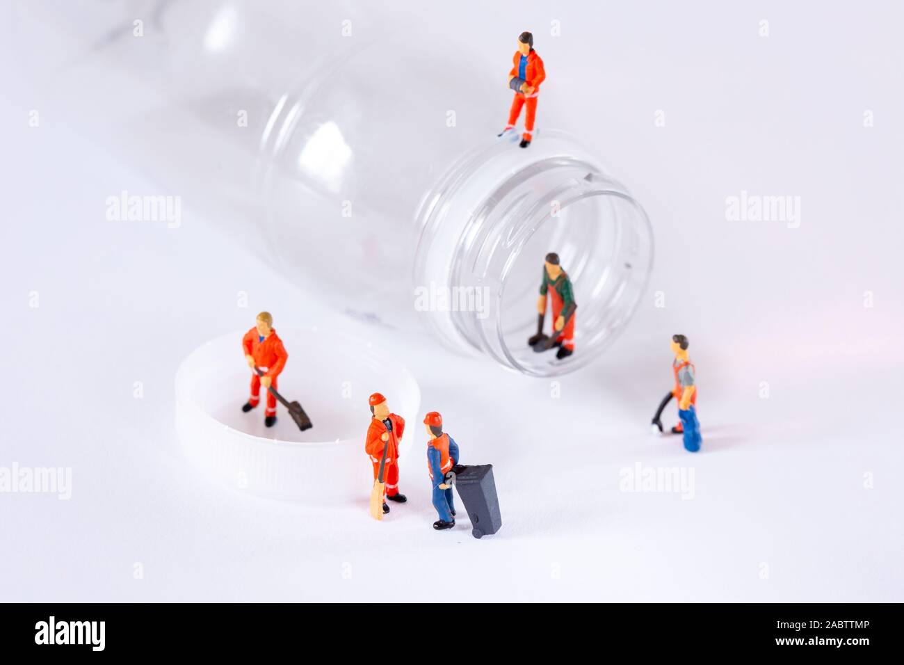 Miniature Workers cleaning and recycling a plastic bottle Stock Photo ...